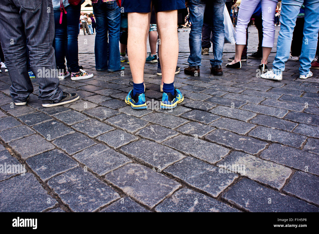 crowd of people legs on a street paved with setts Stock Photo - Alamy