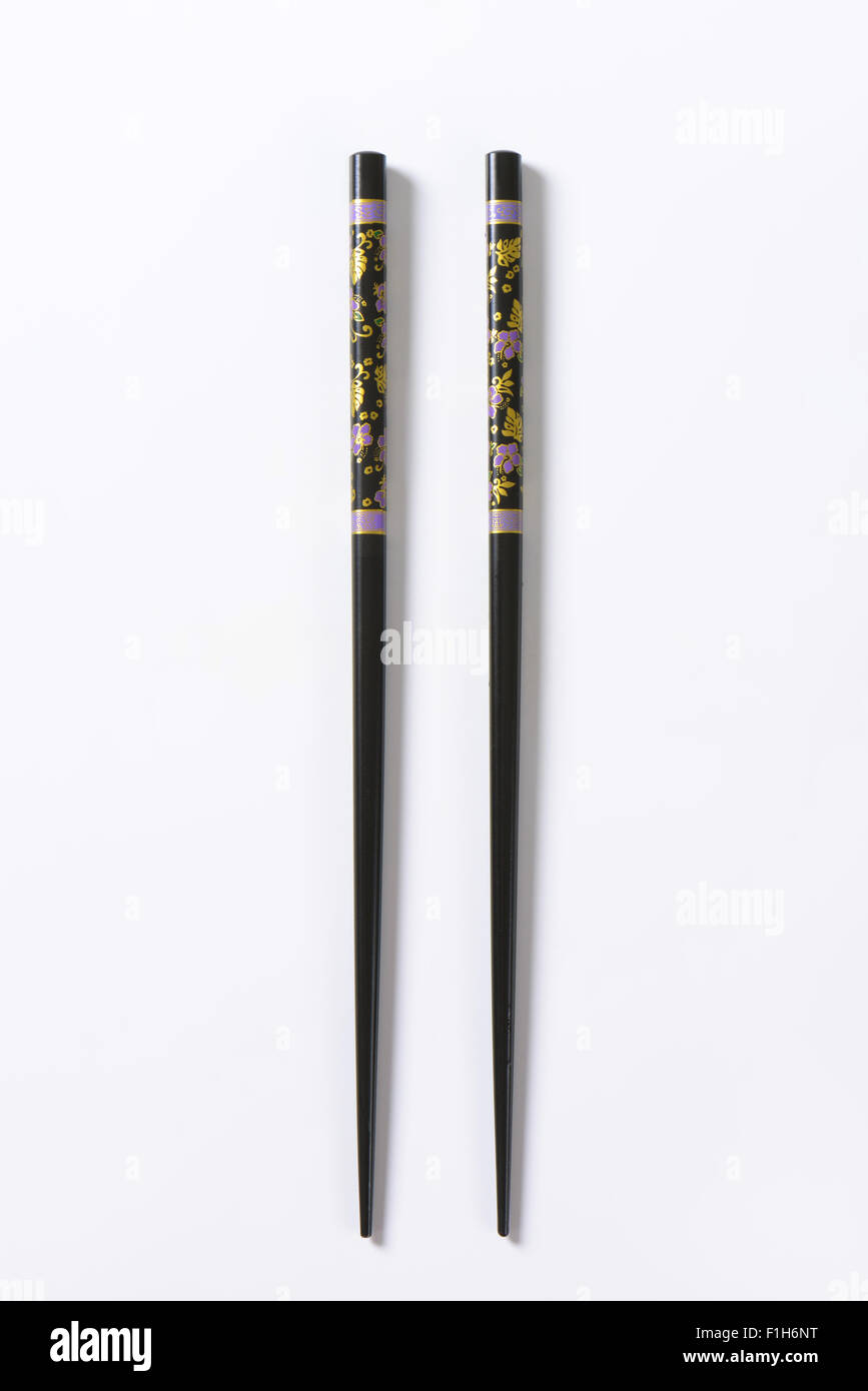 pair of black chopsticks on white background Stock Photo - Alamy