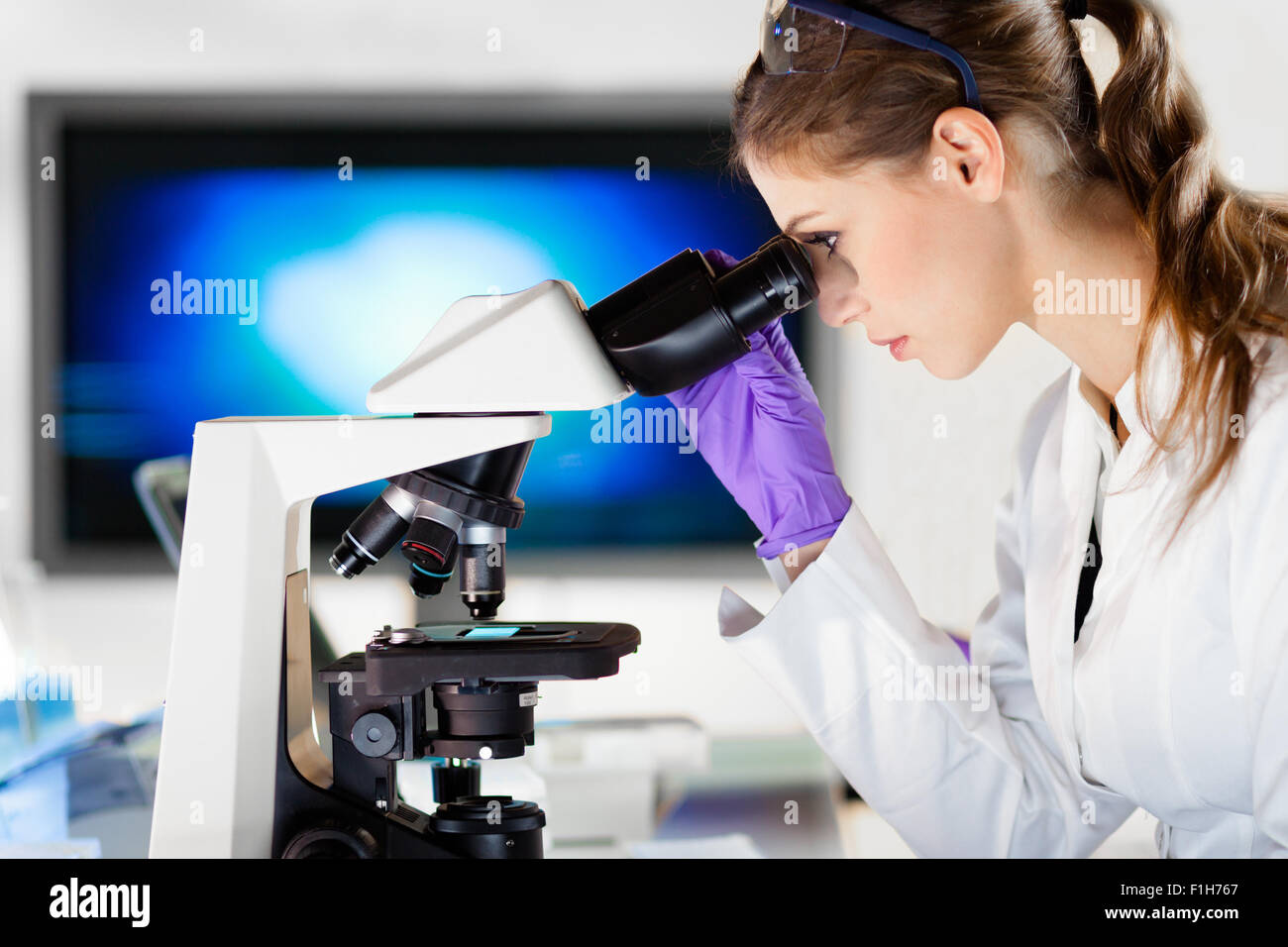 Portrait of a helth care professional microscoping Stock Photo - Alamy