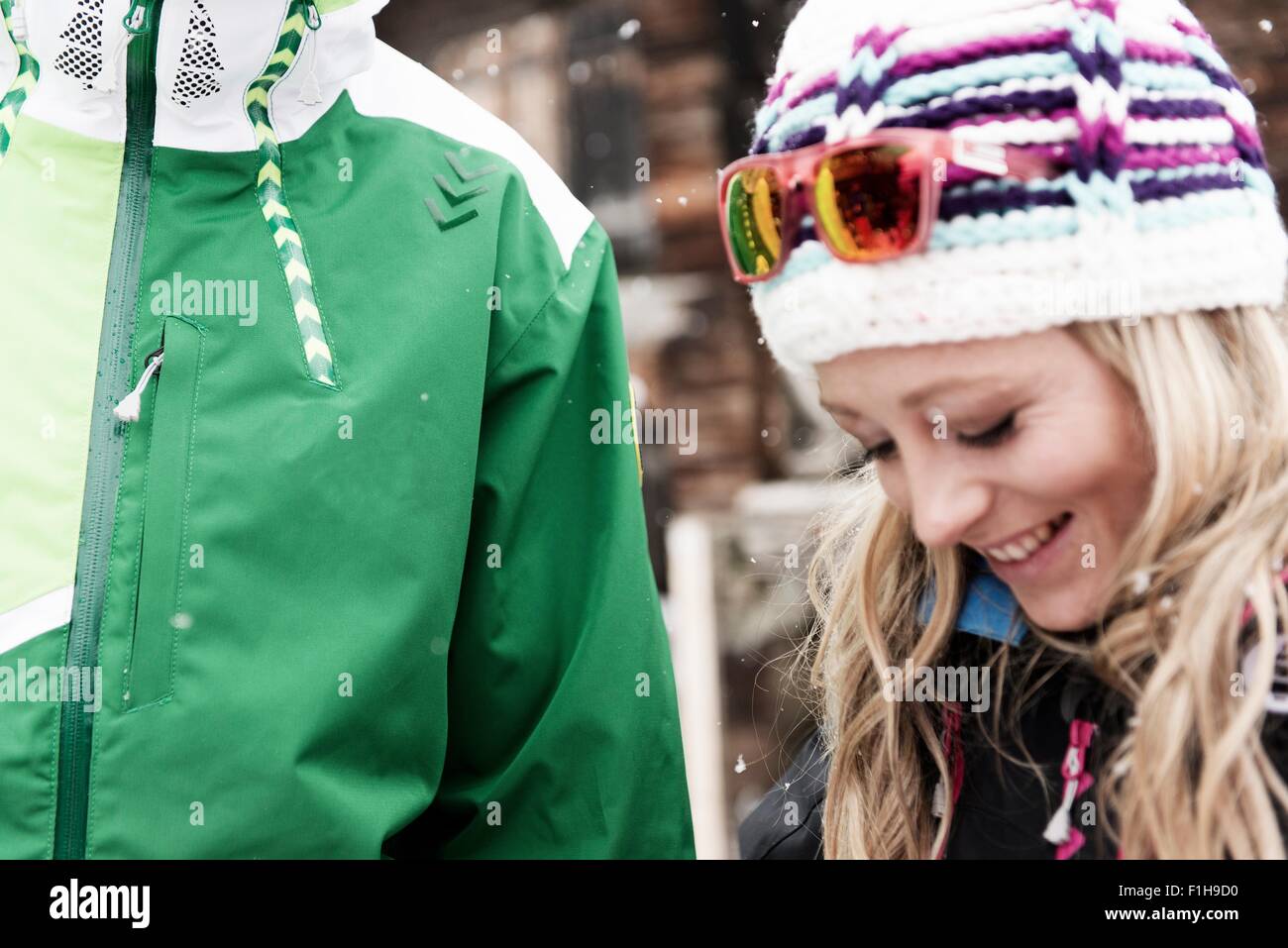 Mid adult woman wearing knit hat, looking down Stock Photo - Alamy