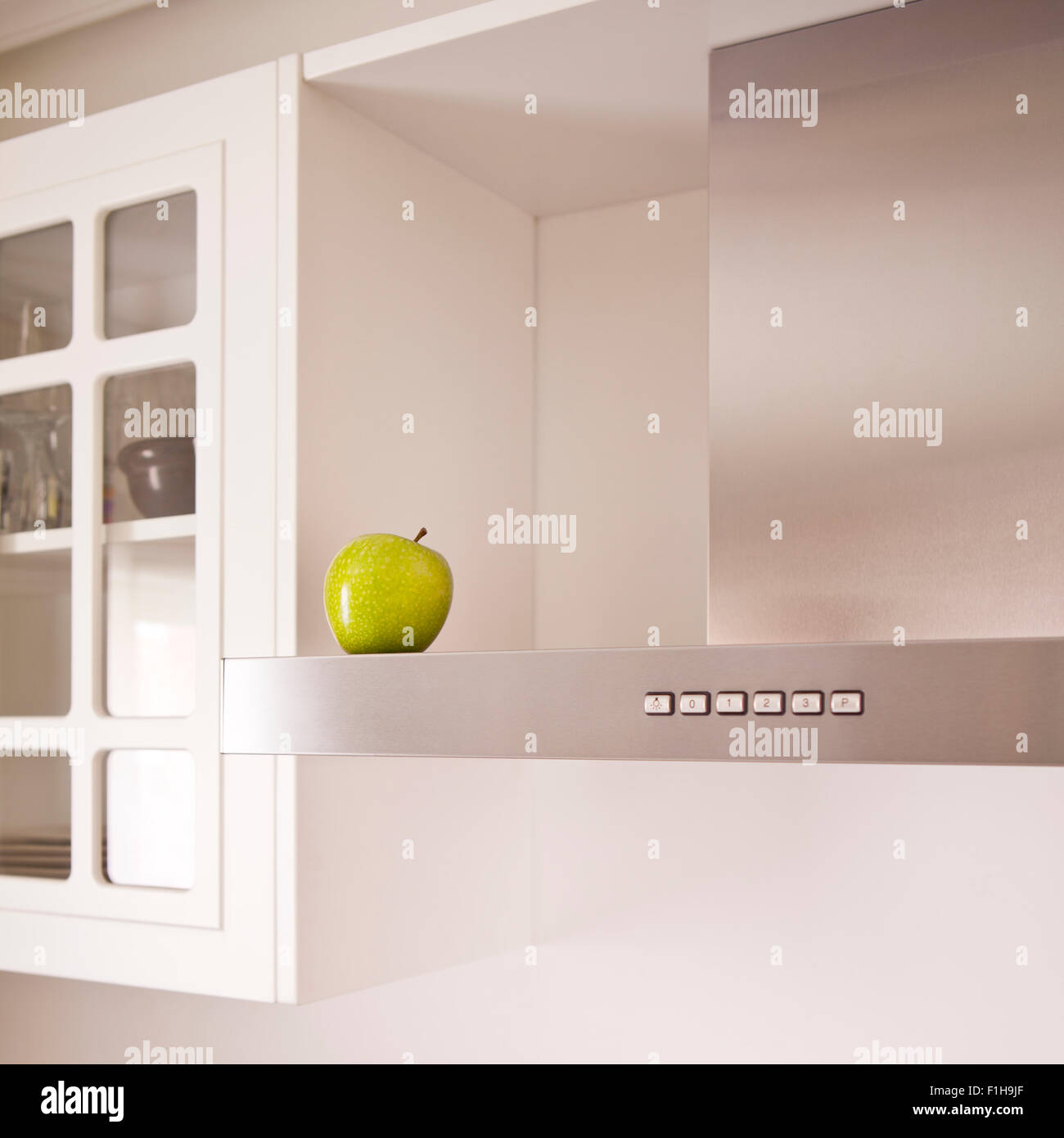 Green apple symbolizing cleanness in a modern white kitchen Stock Photo ...