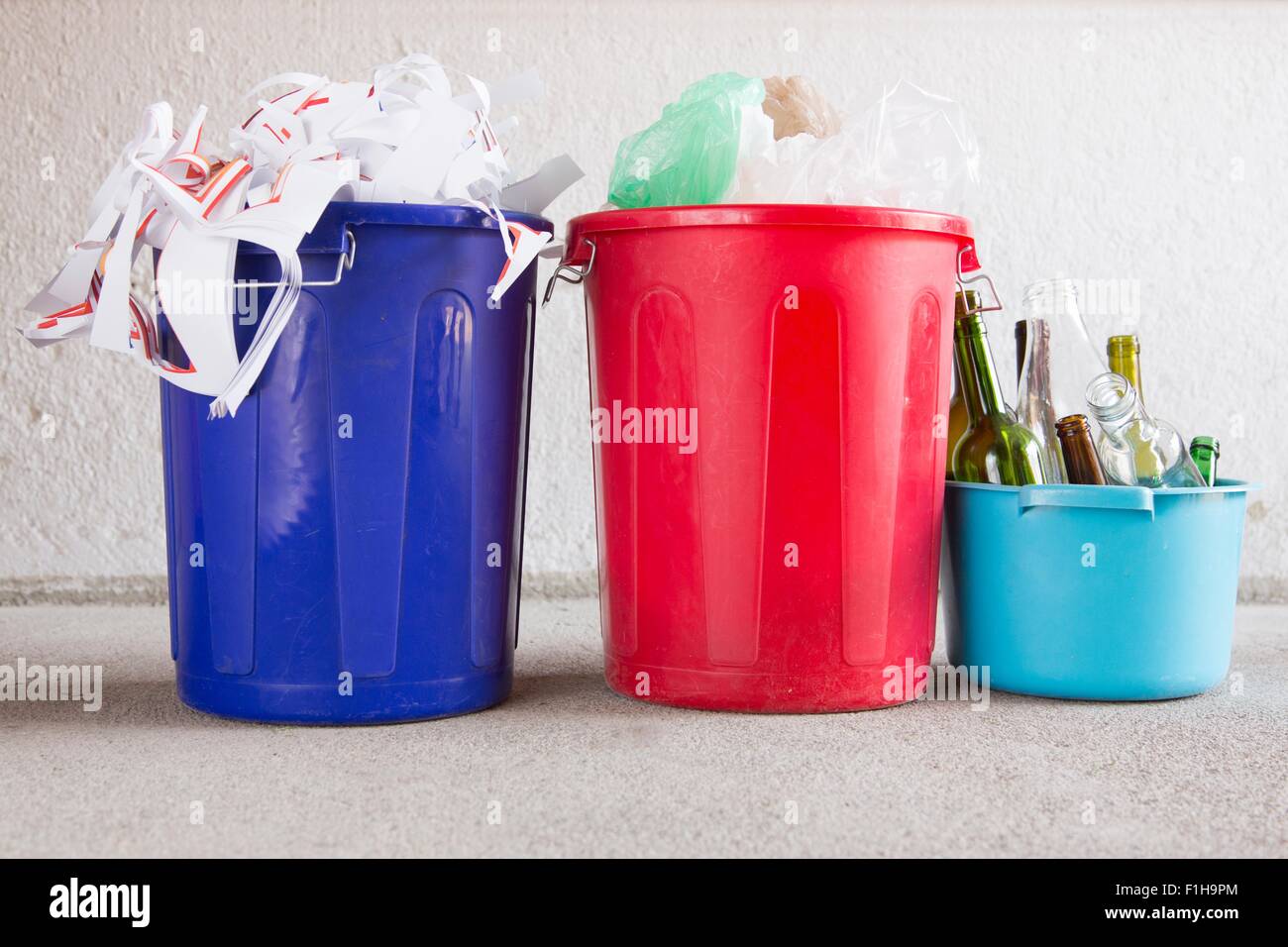 Three recycling buckets in garage with paper, bottles and plastic Stock ...