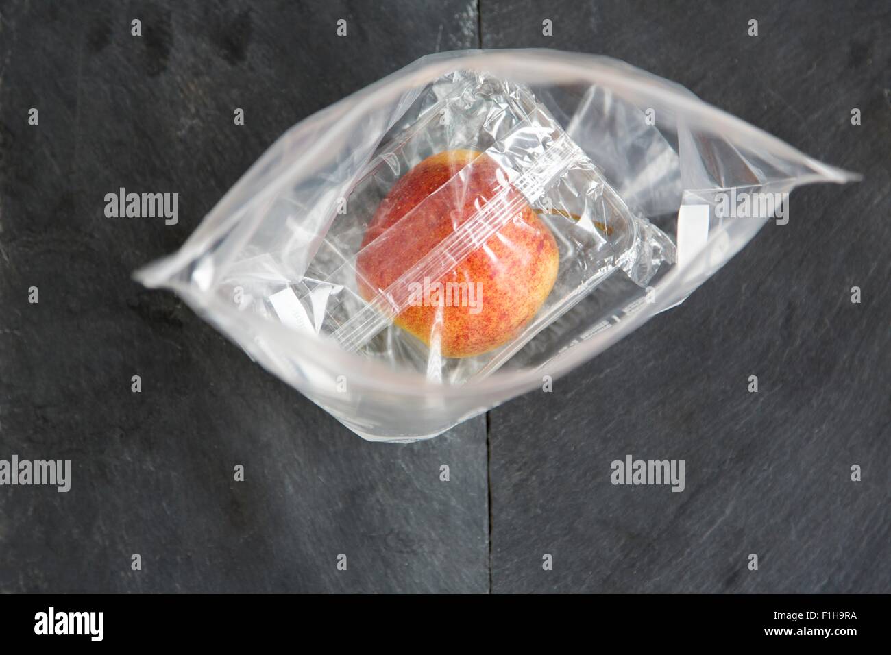 Still life of apple wrapped in plastic bags Stock Photo - Alamy