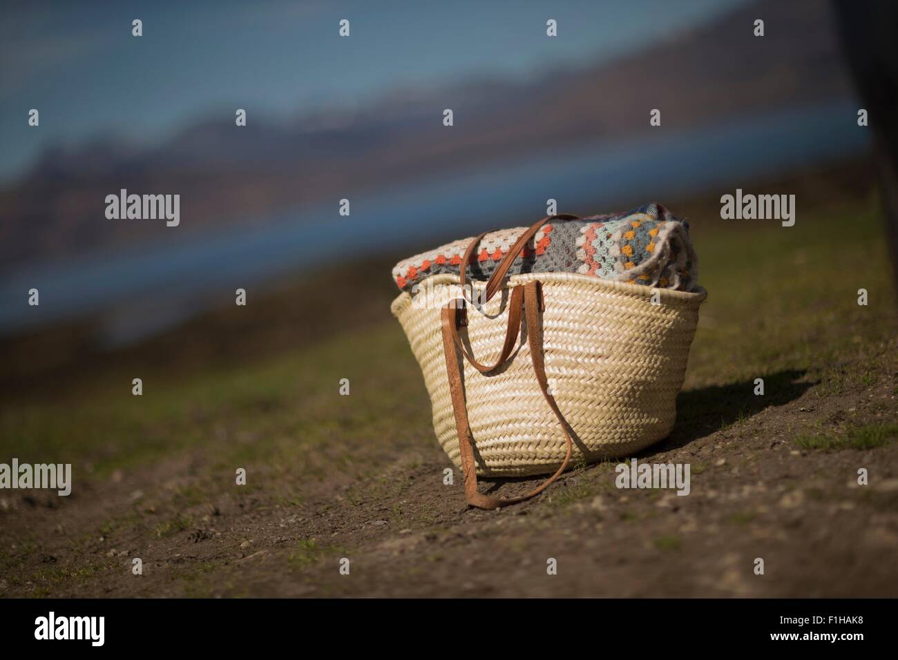 Bag on ground with blanket Stock Photo - Alamy