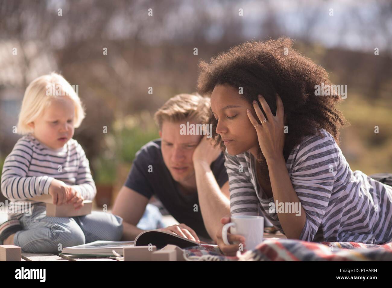 Family relaxing outdoors Stock Photo - Alamy