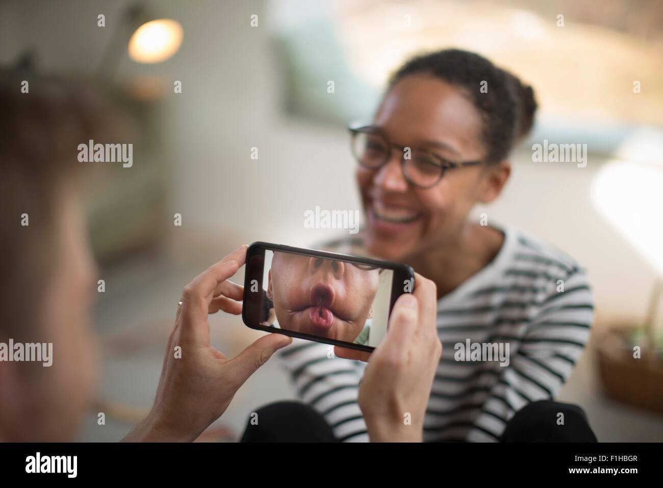 Woman holding smartphone mouth hi-res stock photography and images - Alamy