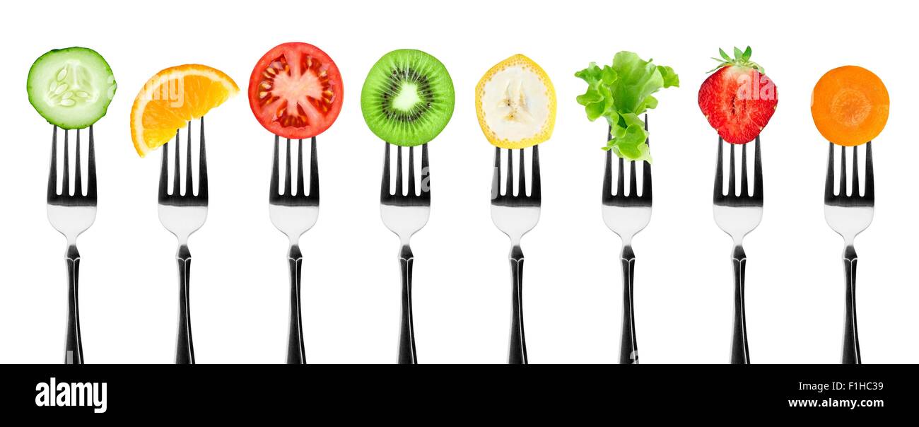 Fruits and vegetables on the forks. Healthy food Stock Photo - Alamy