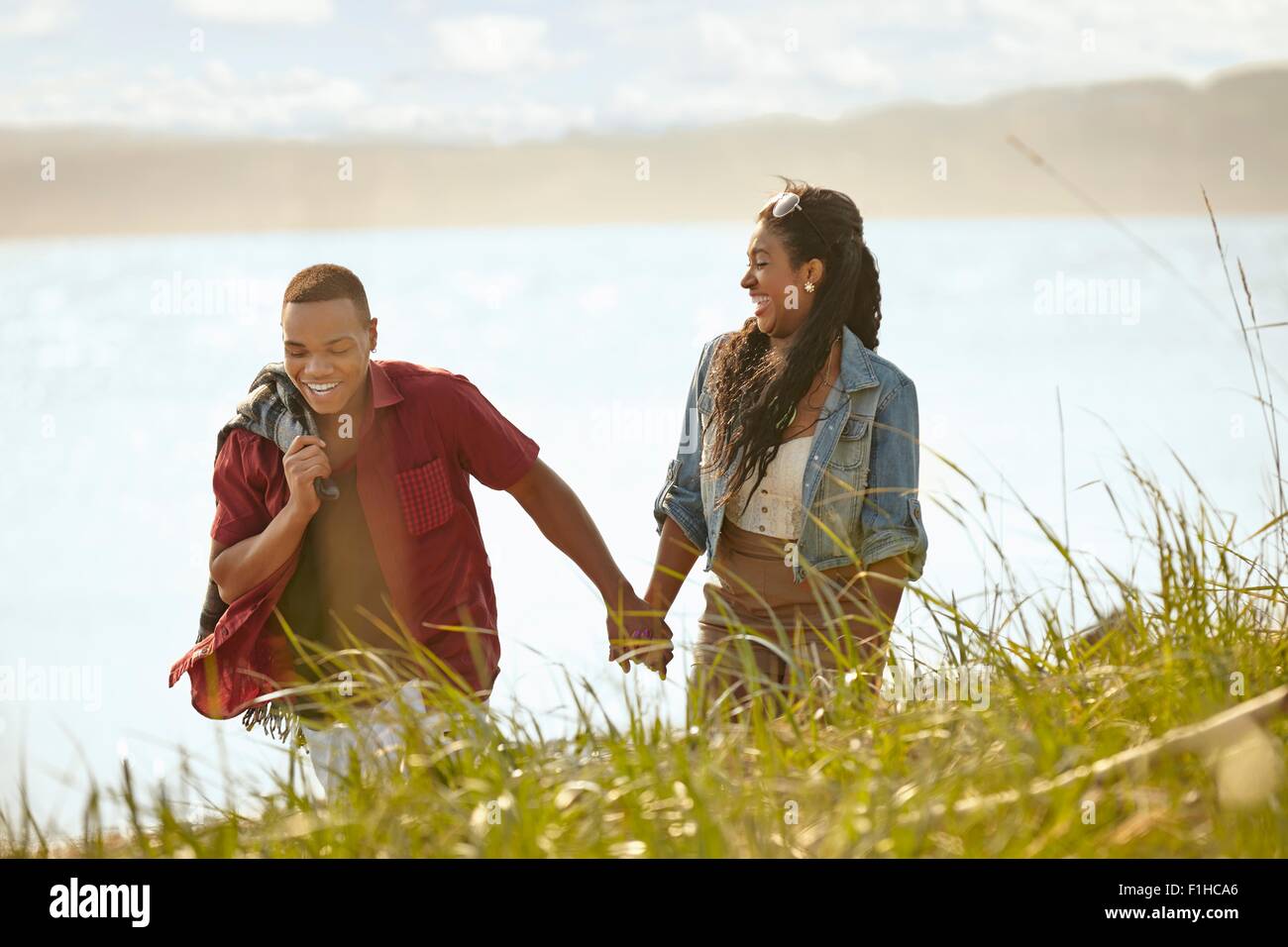 Young couple strolling holding hands Stock Photo - Alamy
