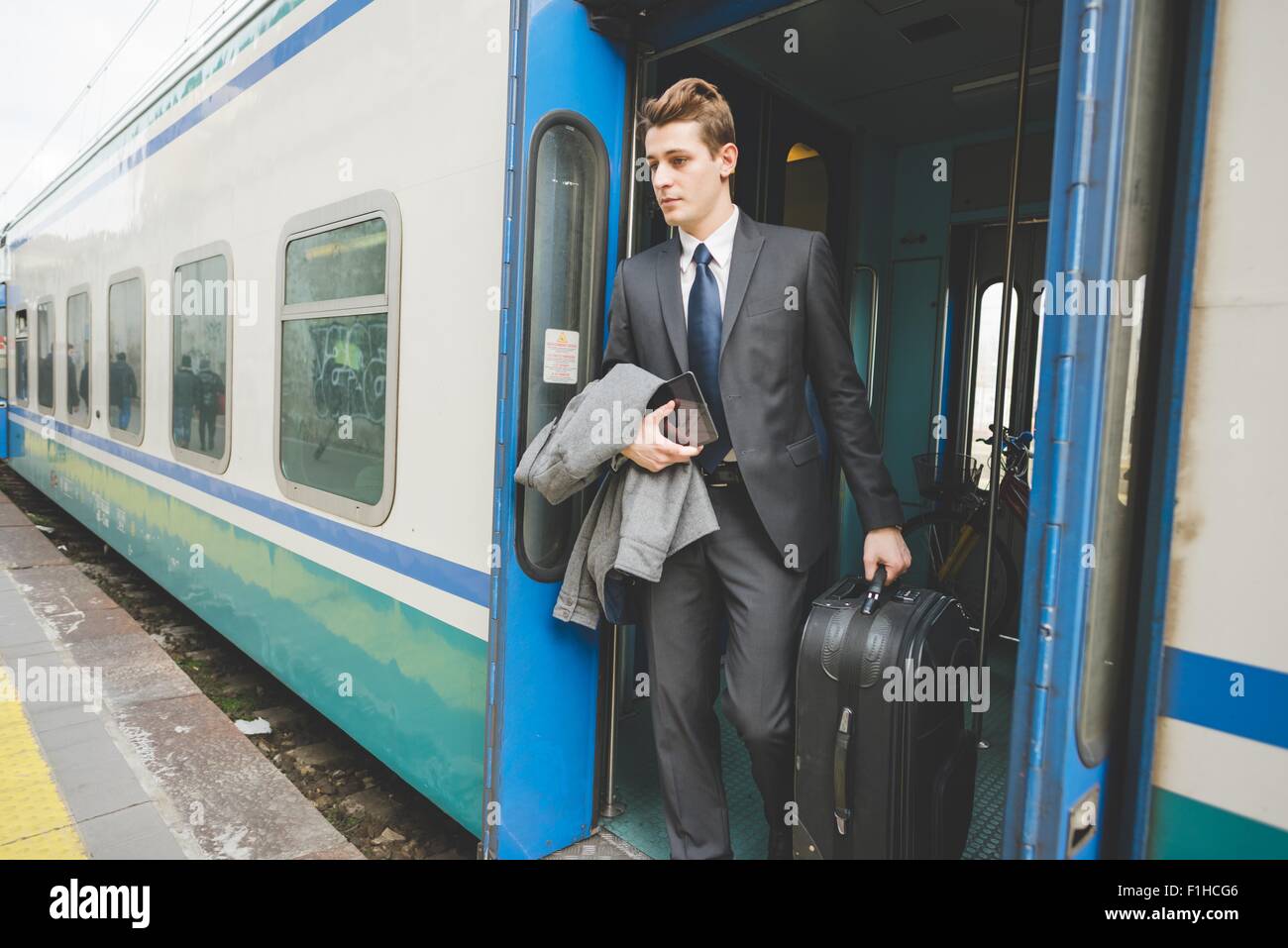 Exiting businessman holding smartphone hi-res stock photography and ...