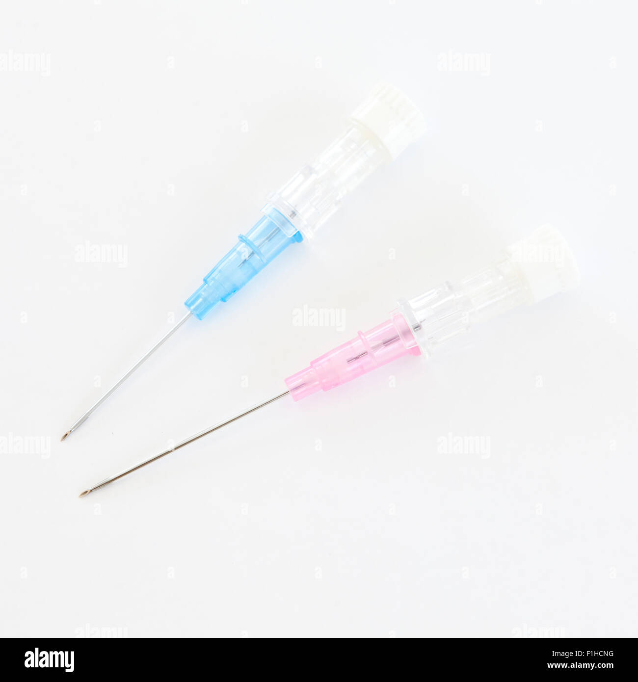 Pink and blue needles isolated in white Stock Photo - Alamy