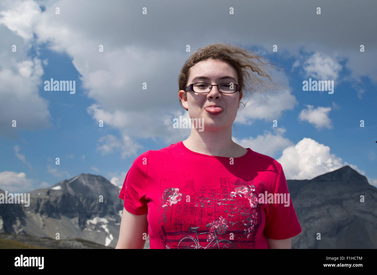 Young teenage girl in the Swiss Alps sticks her tongue out Stock Photo ...