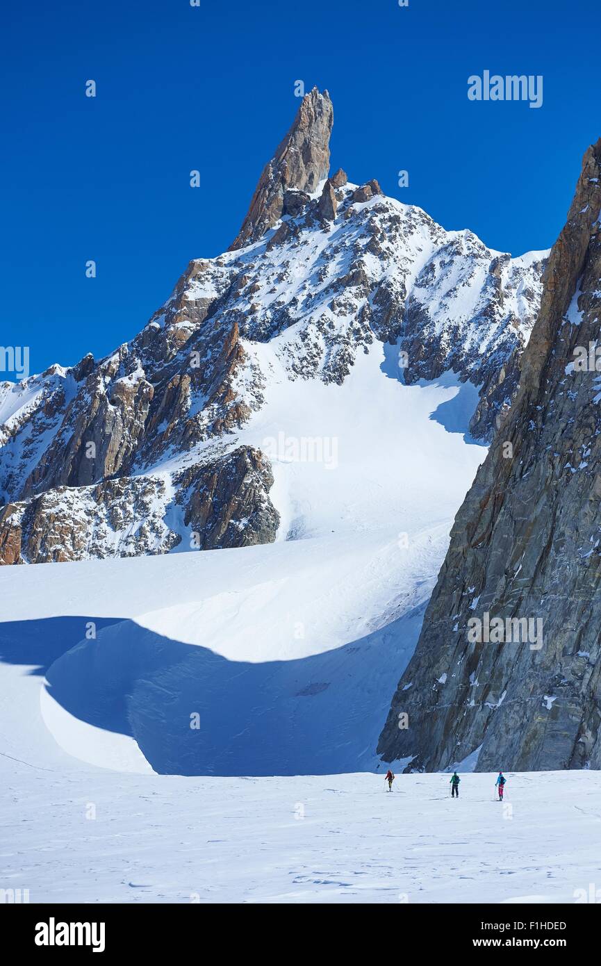 Distant view of three skiers on Mont Blanc massif, Graian Alps, France ...