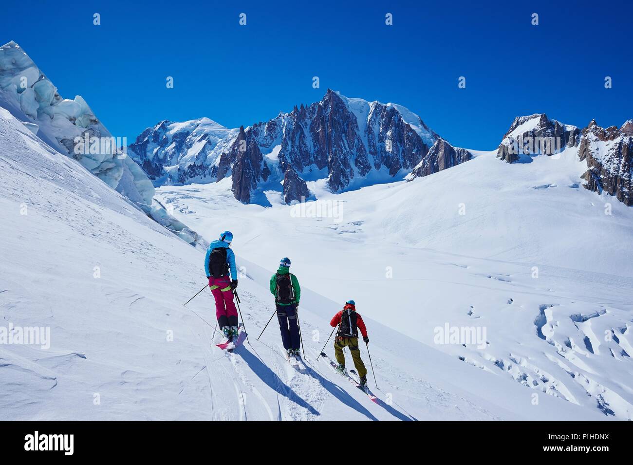 Three adult skiers side by side on Mont Blanc massif, Graian Alps ...