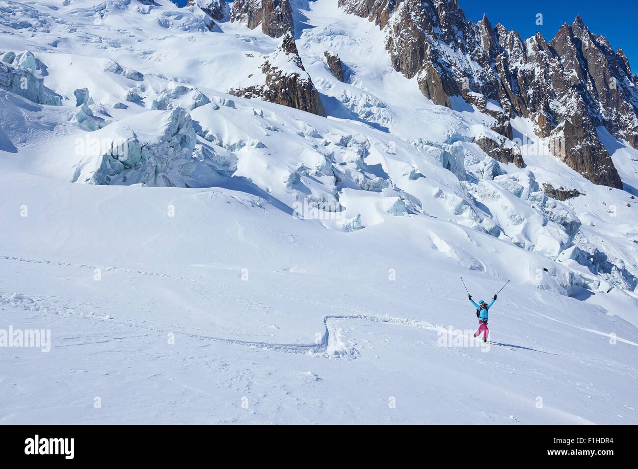 Mature female skier celebrating on Mont Blanc massif, Graian Alps ...