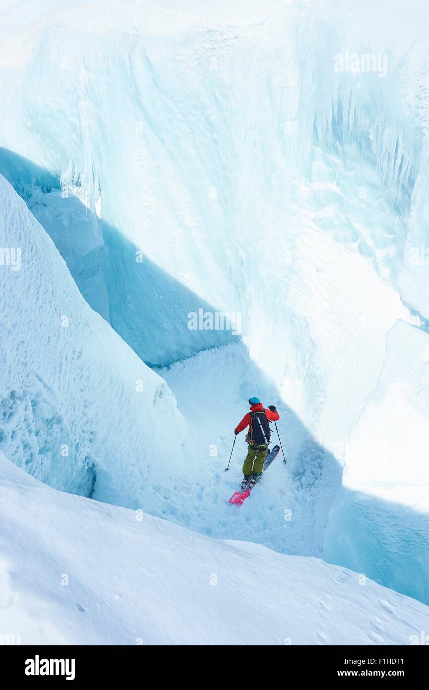Male skier skiing down ravine on Mont Blanc massif, Graian Alps, France ...