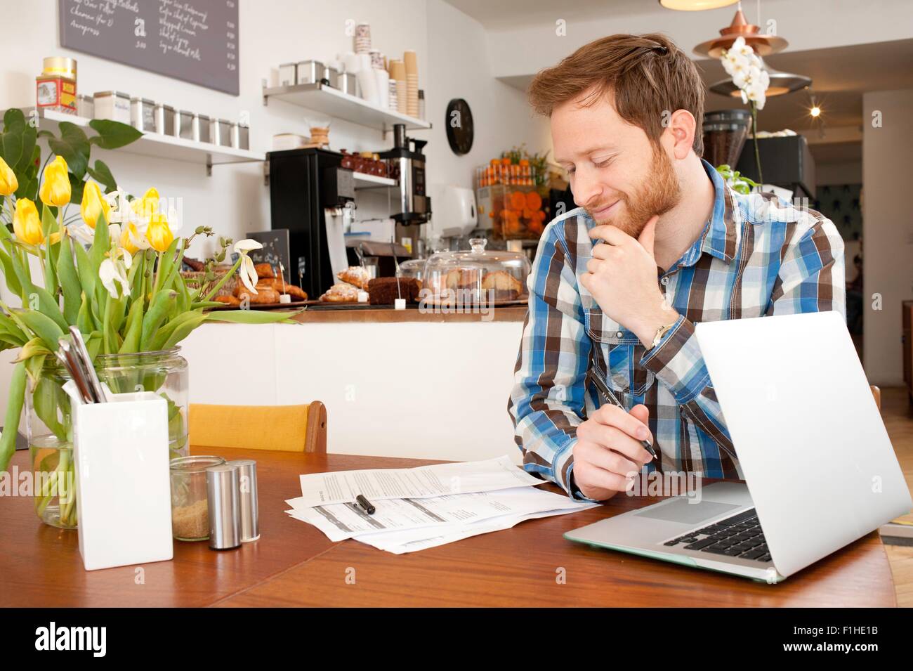 Male customer filling in application form in cafe Stock Photo - Alamy