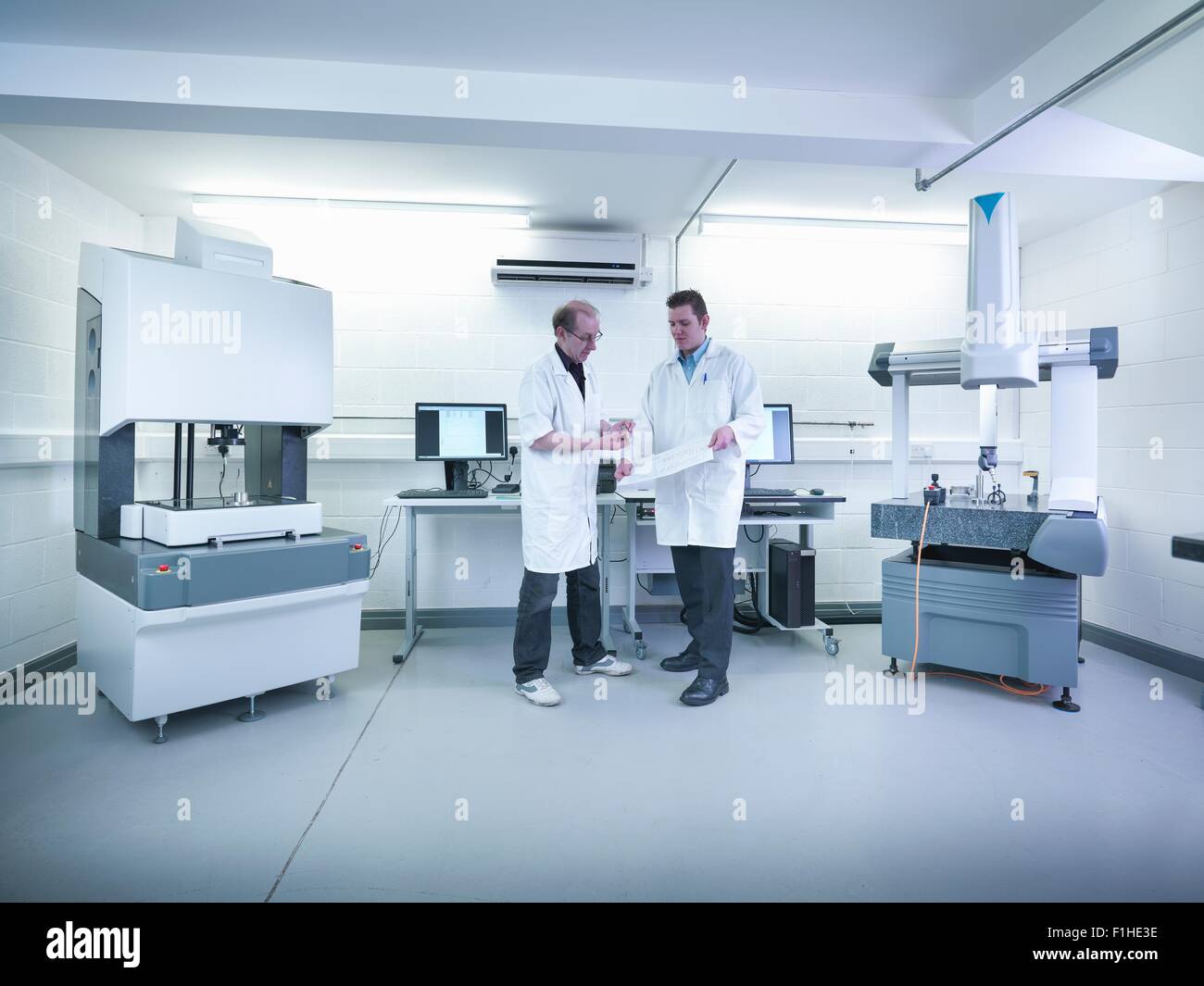 quality-control-engineers-in-discussion-amongst-measuring-machinery