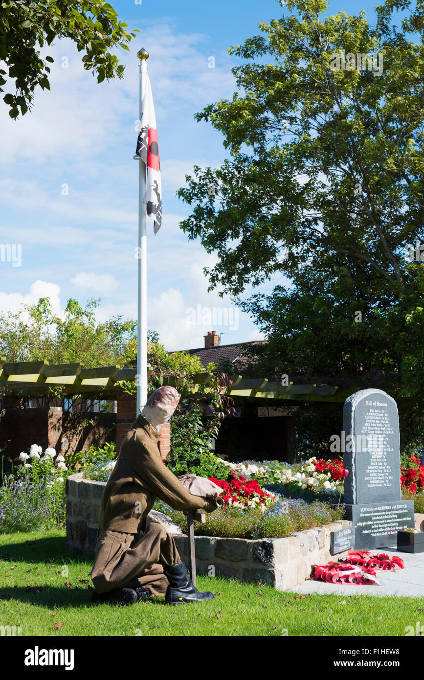 A scarecrow soldier pays his respects at the village war memorial ...