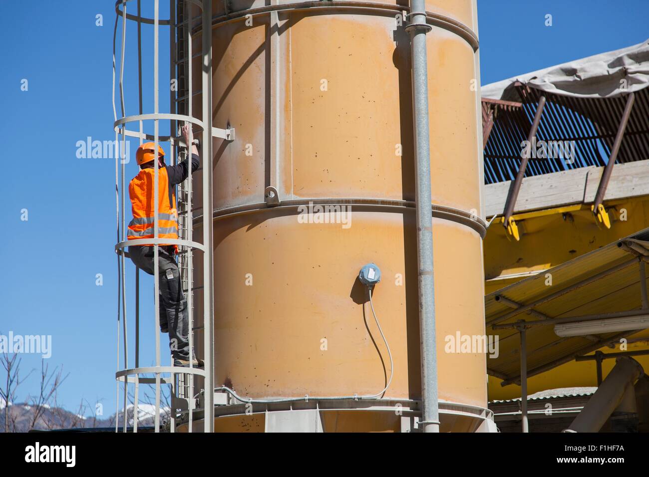 Quarry worker climbling smoke stack ladder at gravel quarry Stock Photo ...
