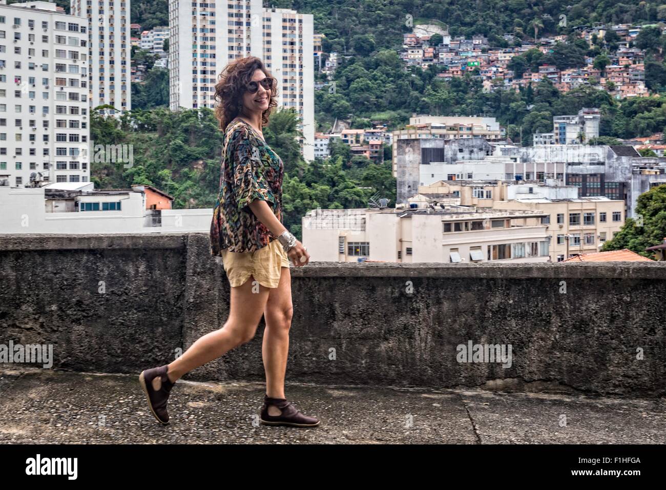 Fashion model walking and smiling at camera Stock Photo - Alamy
