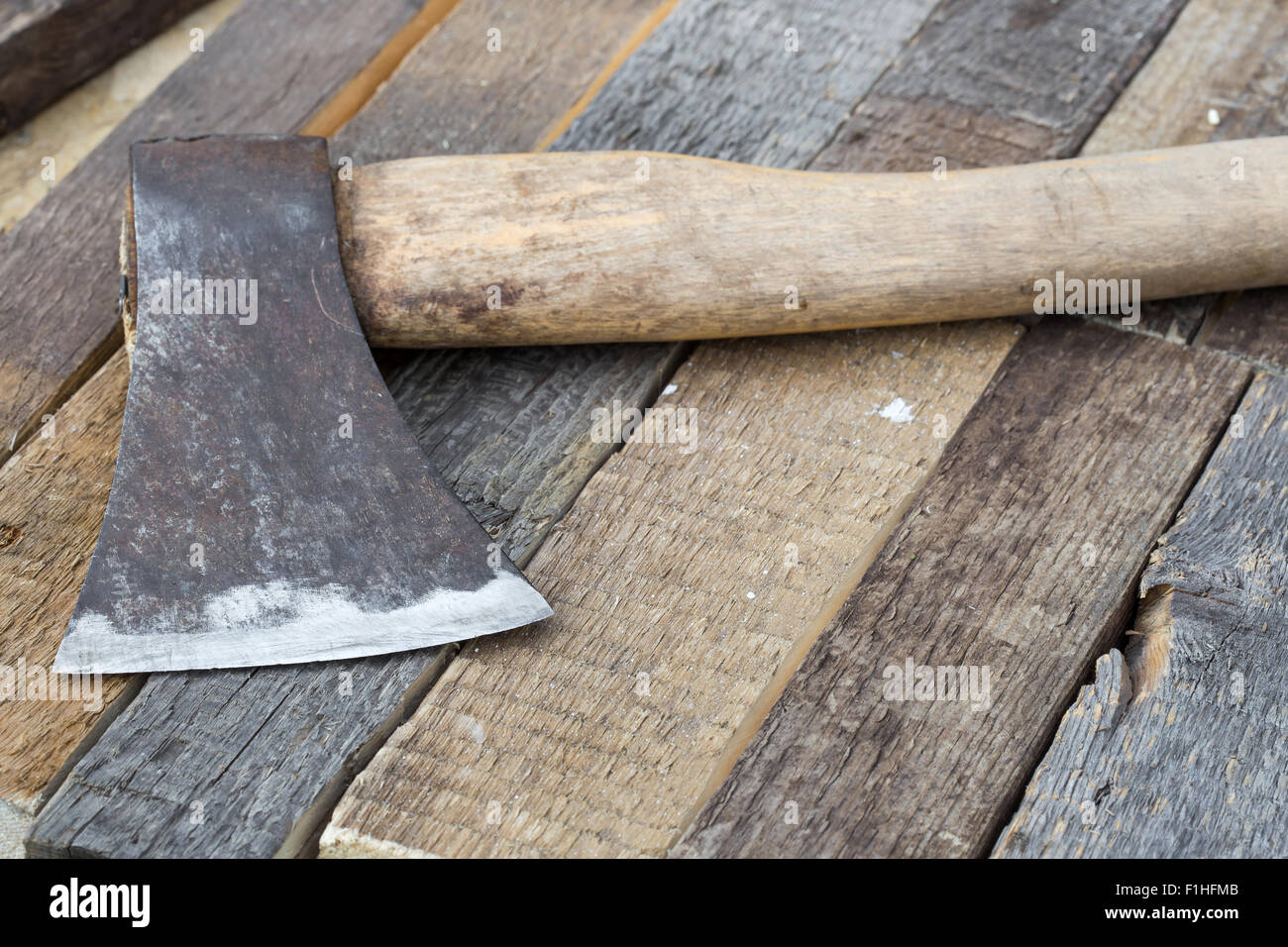 Old axe on a wooden background, closeup Stock Photo - Alamy
