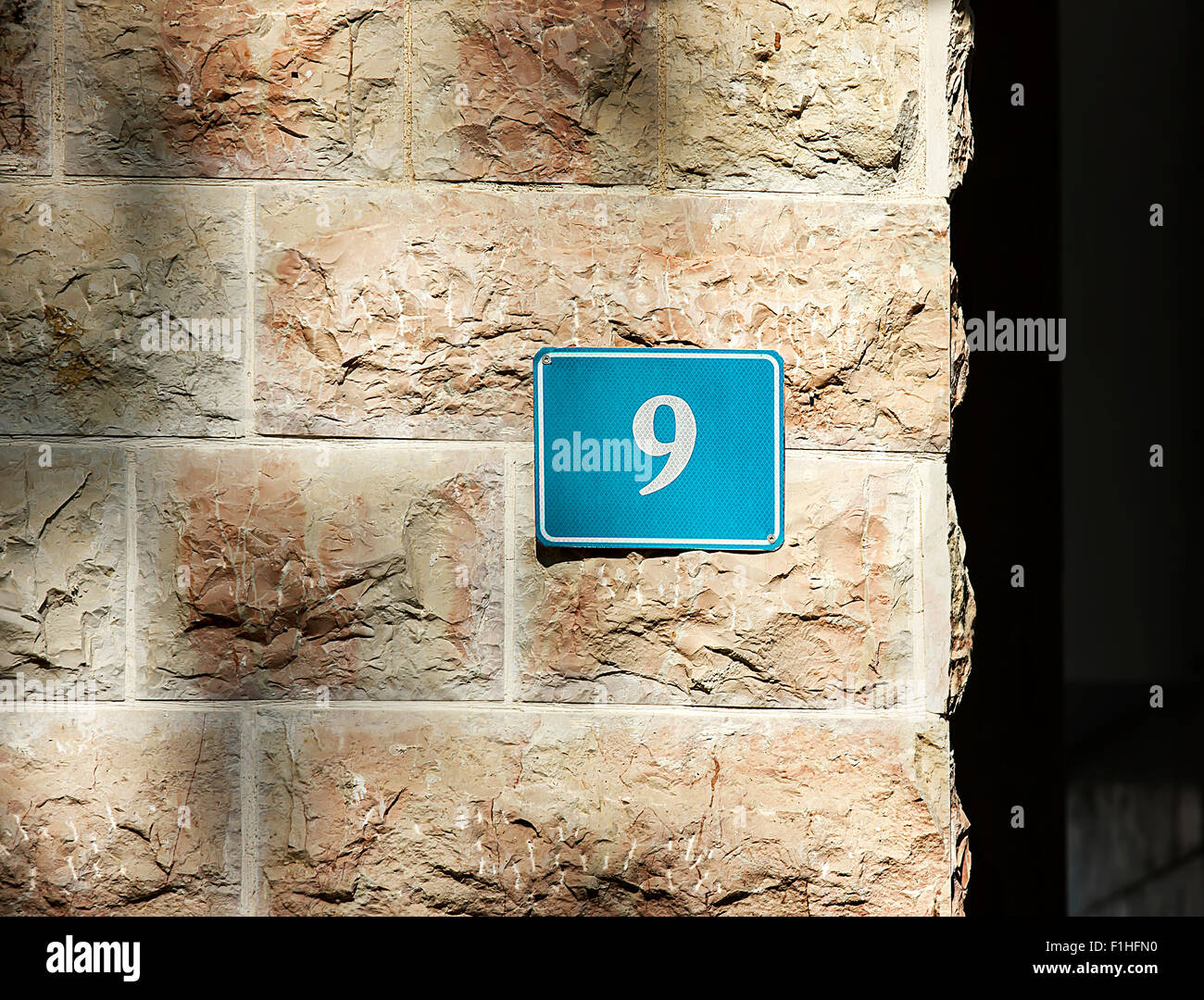 Plate with number nine, detail of an metal plate with information and ...