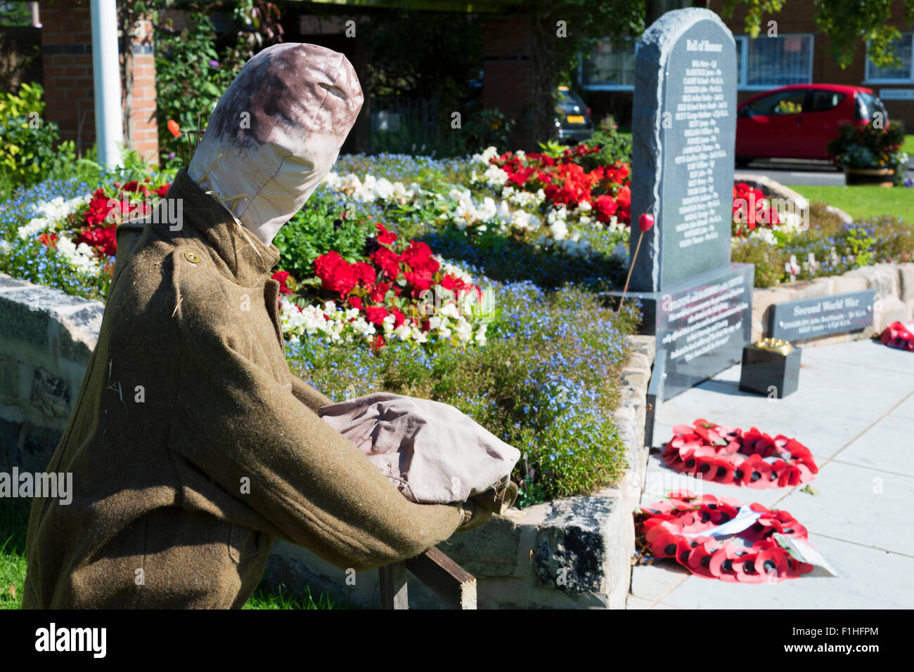 A scarecrow soldier pays his respects at the village war memorial ...