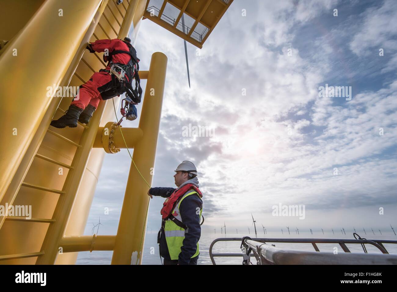 Man climbing wind turbine man wind farm hi-res stock photography and ...