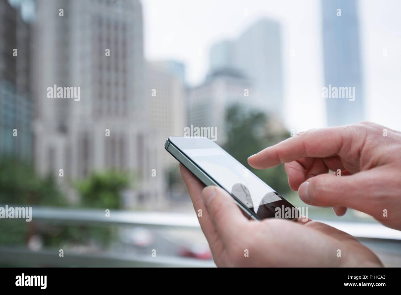 Man using smartphone outdoors, focus on hands, Hong Kong, China Stock ...