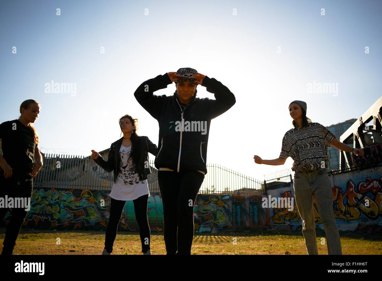 Young woman wearing baseball cap looking at camera Stock Photo - Alamy