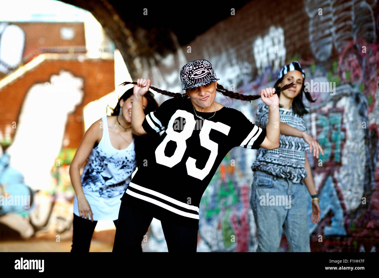 Young woman dancing, looking at camera with attitude Stock Photo - Alamy