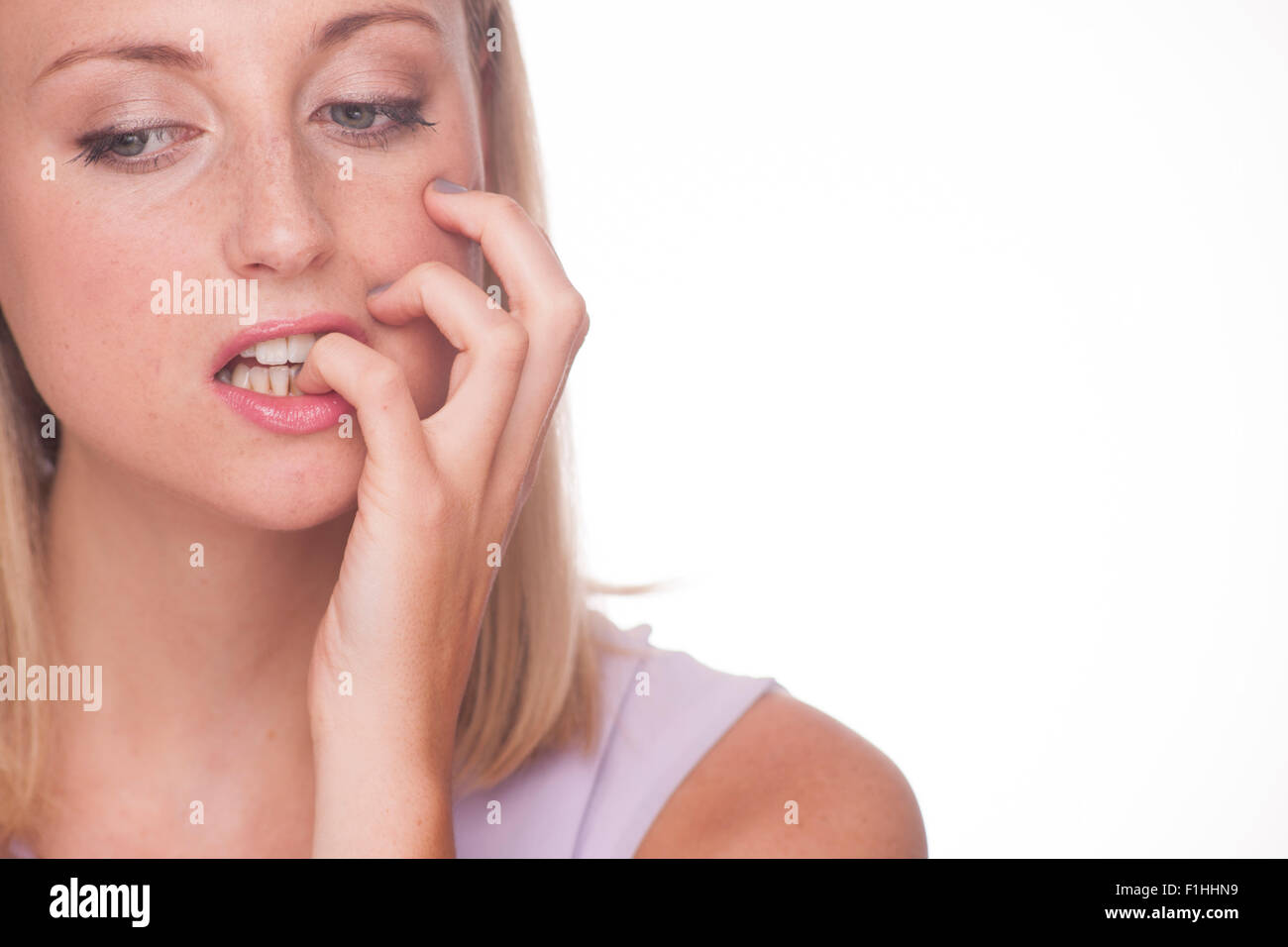 Biting her fingernail hi-res stock photography and images - Alamy