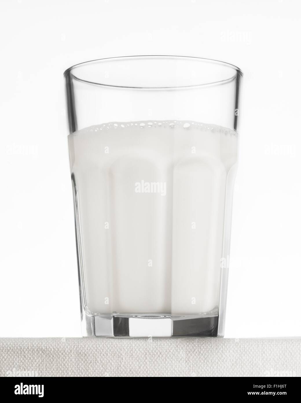 Close up of drinking glass of frothy effervescent water Stock Photo - Alamy