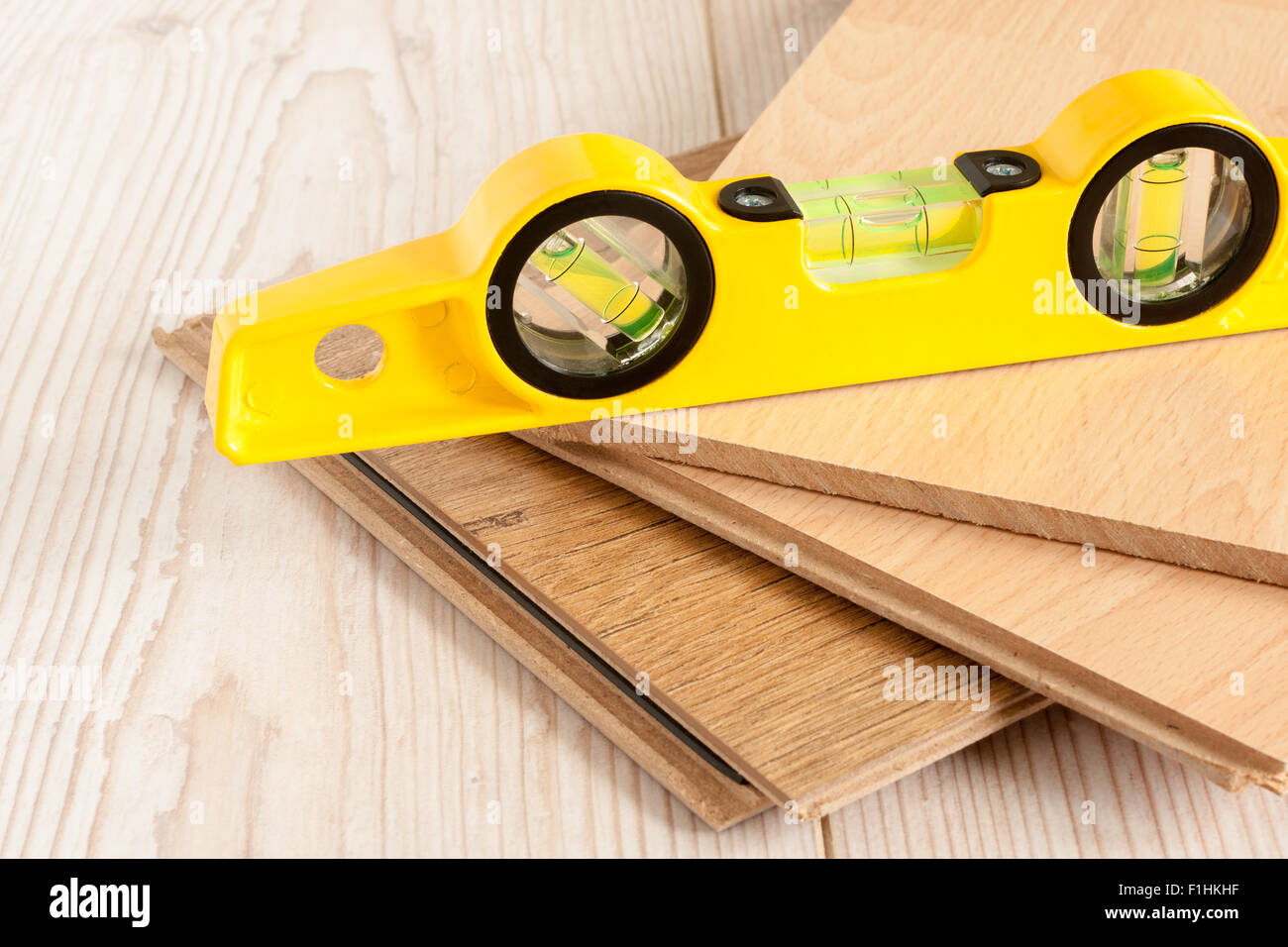 Pieces of wood laminate flooring ready to be laid with a carpenters ...
