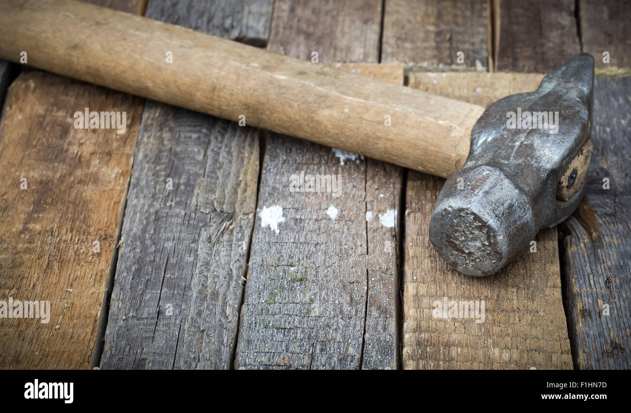 Hammer on a wooden background with copy space Stock Photo - Alamy