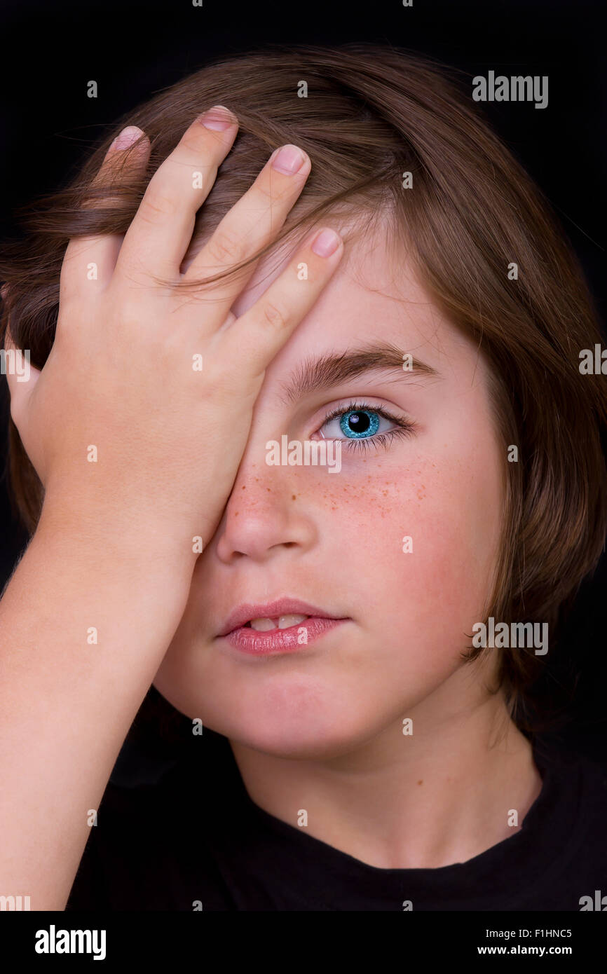 Portrait of cute little boy closed one eye with his hand. studio Stock ...