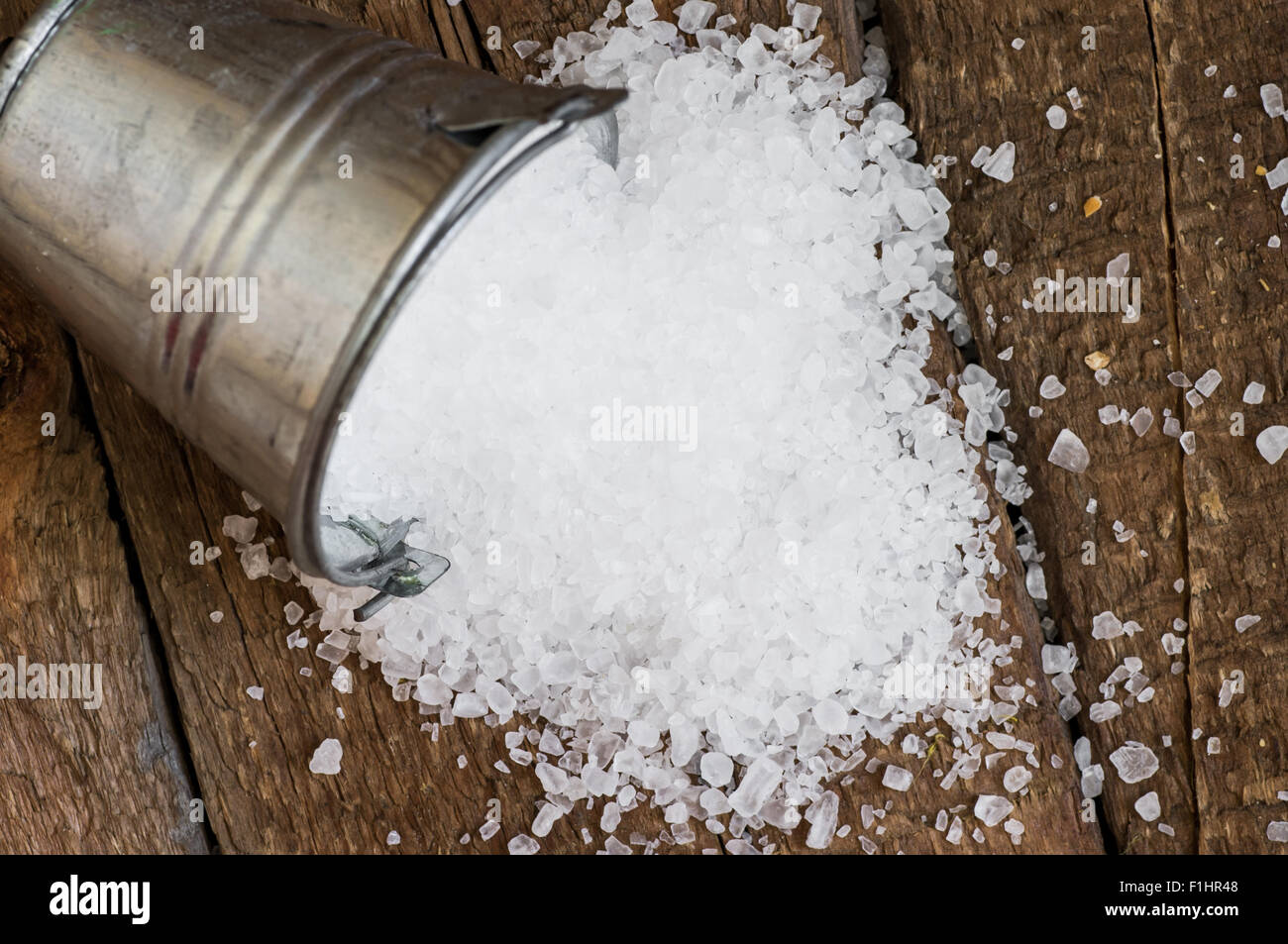 Salt is scattered on the wooden table top view Stock Photo - Alamy