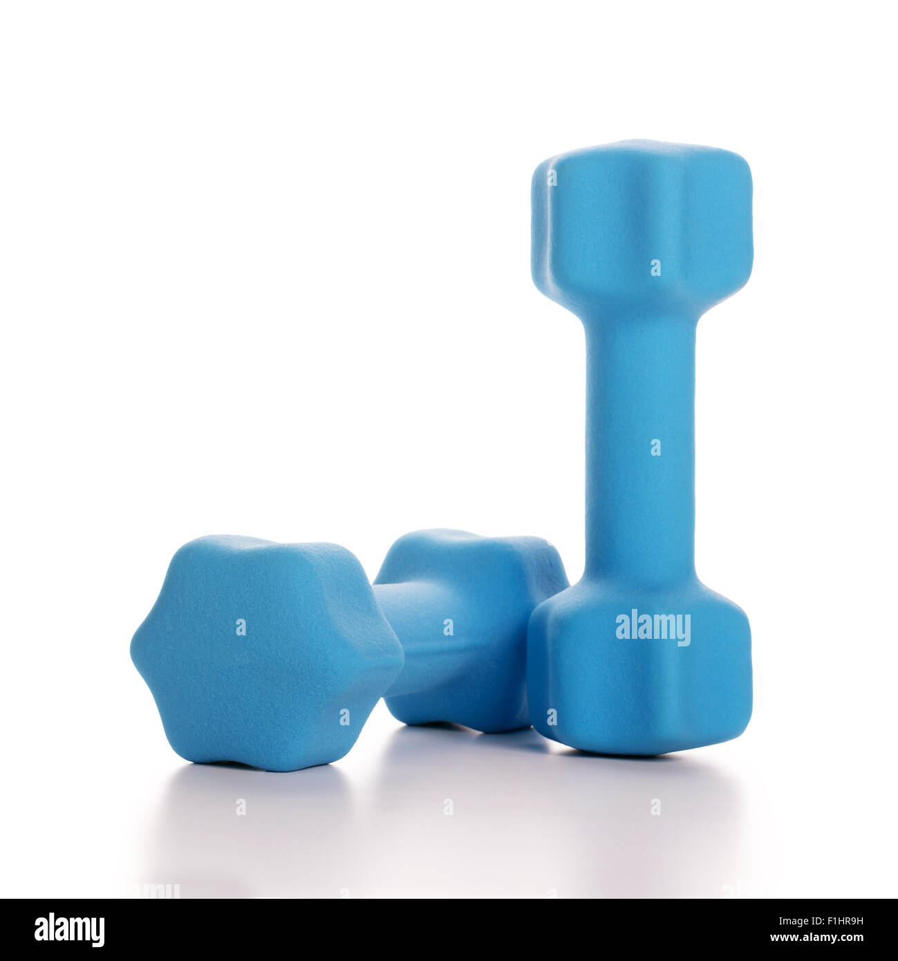 Fitness concept with two blue dumbbells on white background, closeup ...