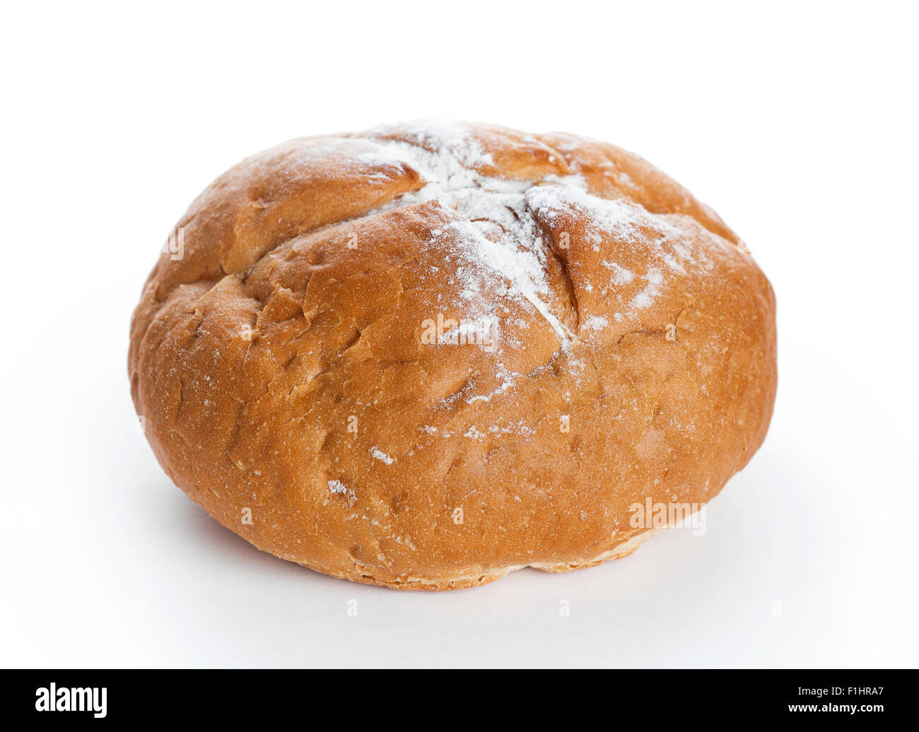 Homemade whole round bread sprinkled with flour closeup on white ...