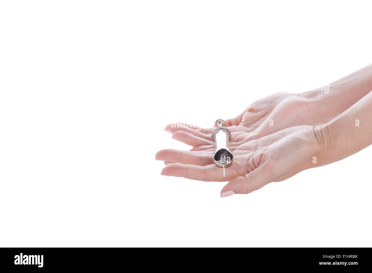Old glass multiple use syringe in female hand, closeup on white ...