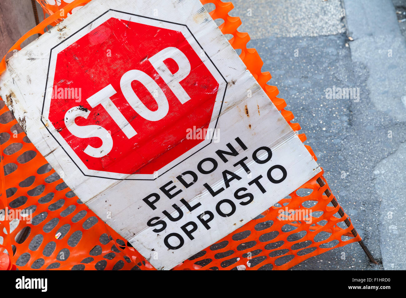 Road barrier with stop sign and text on Italian means pedestrians on ...
