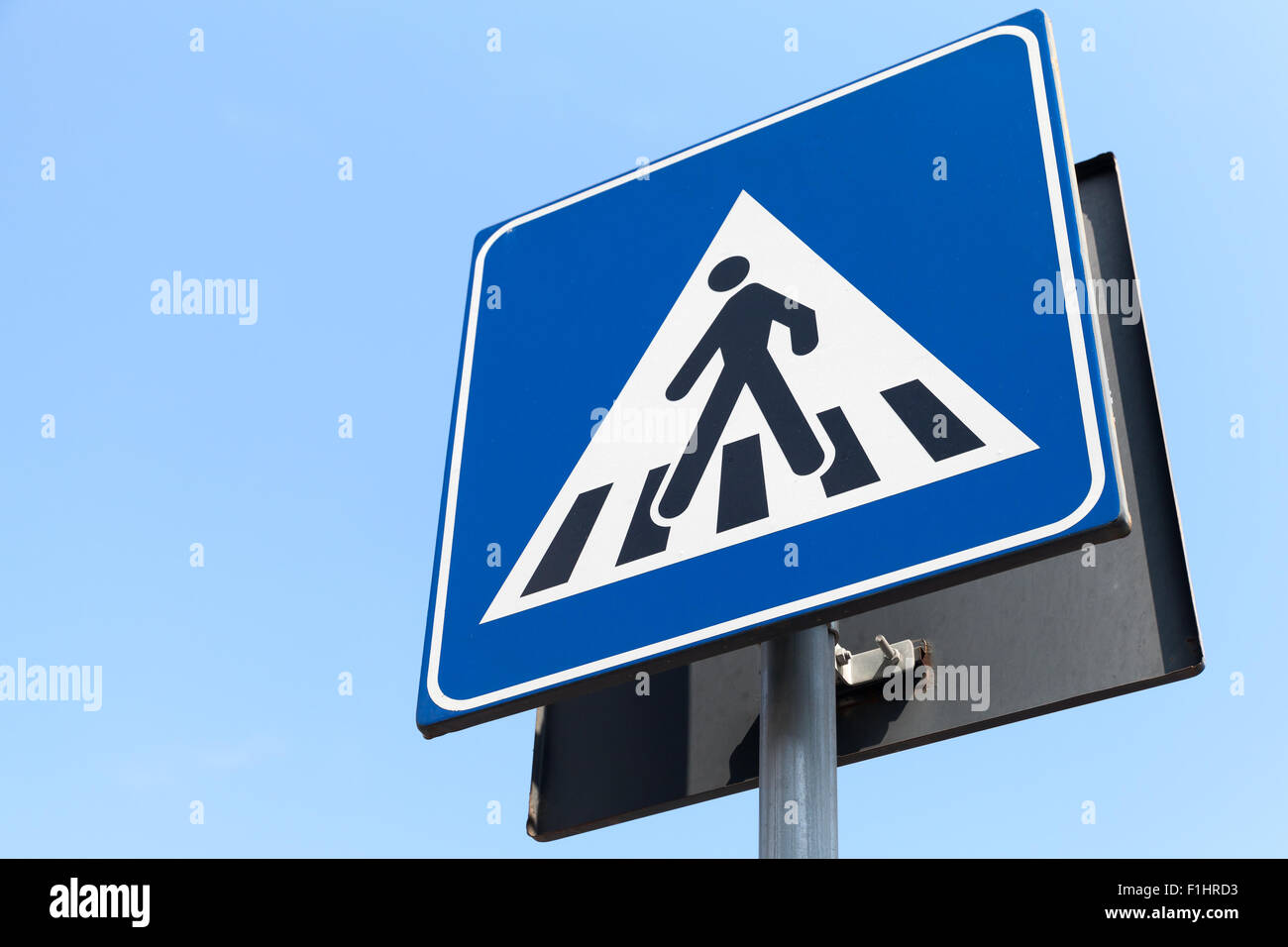 Pedestrian crossing. Modern two-sided road sign above blue sky ...