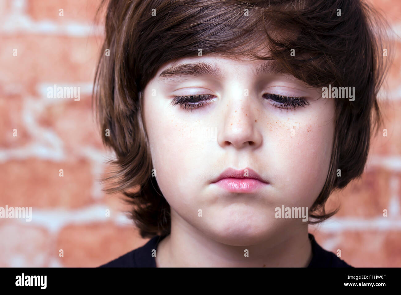 Handsome boy looking down Stock Photo - Alamy