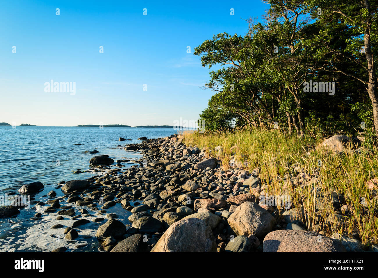 sunset on rocky coast in southern finland Stock Photo - Alamy