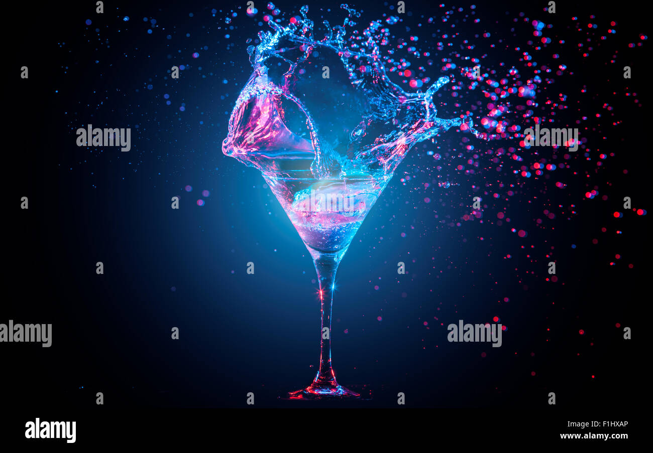 Blue cocktail with splashing water Stock Photo - Alamy