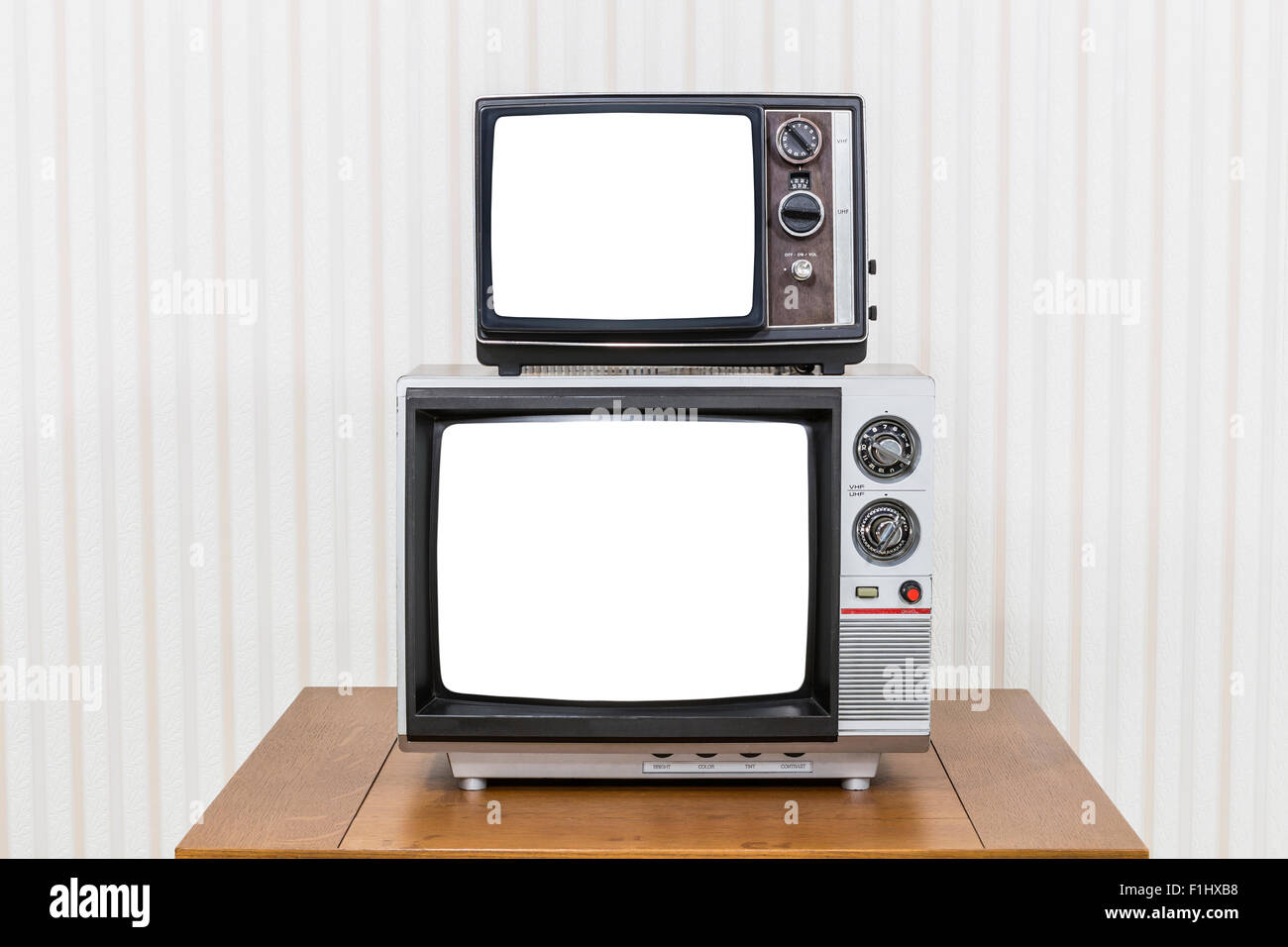 Vintage television stack on old wood table with cut out screens Stock ...