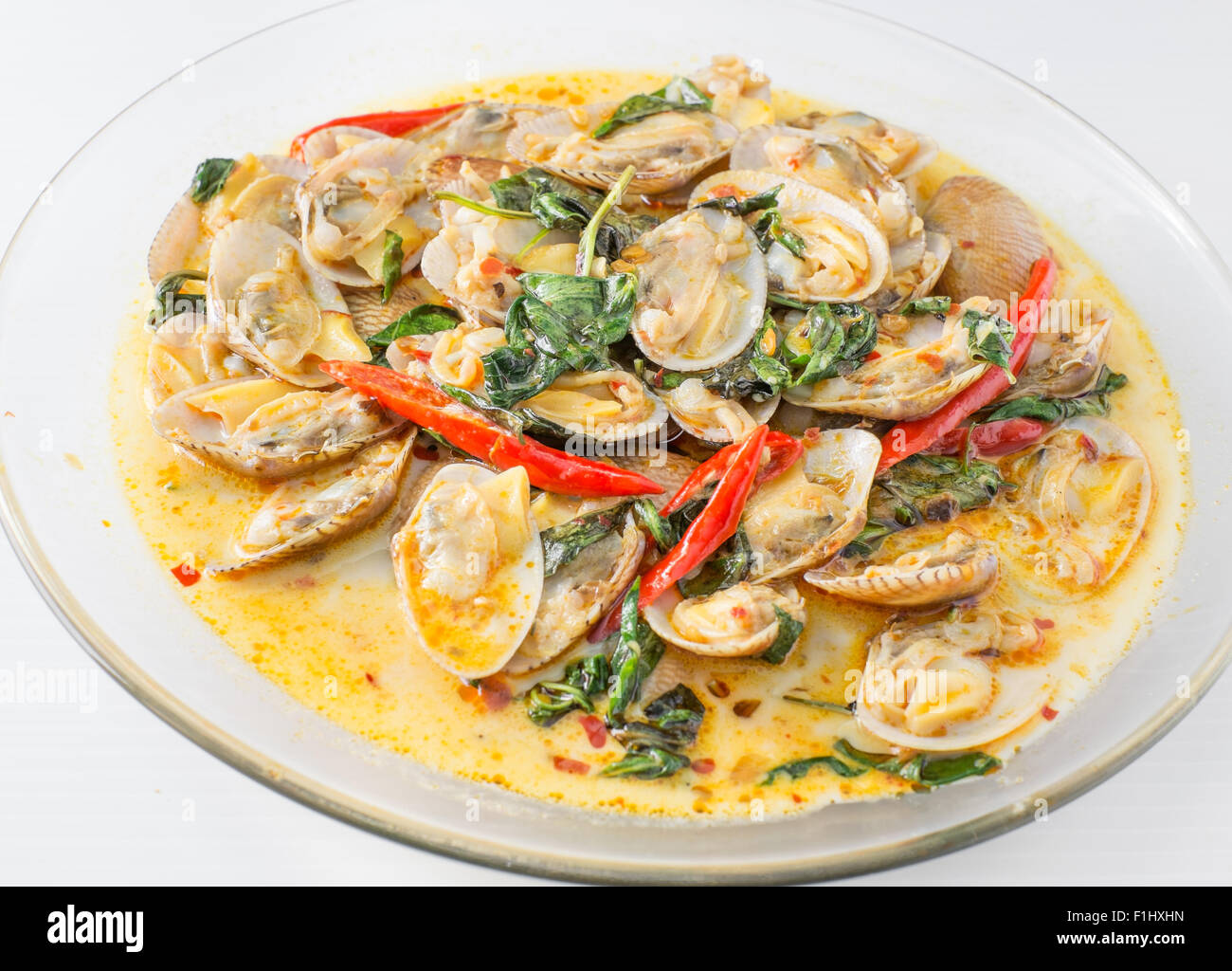 STIR FRIED CLAMS WITH ROASTED CHILI PASTE AND THAI BASIL LEAVES Stock ...