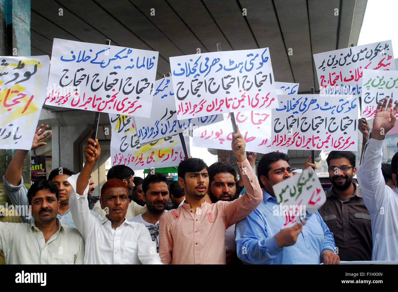 Members of business community chant slogans against the imposition of 0 ...