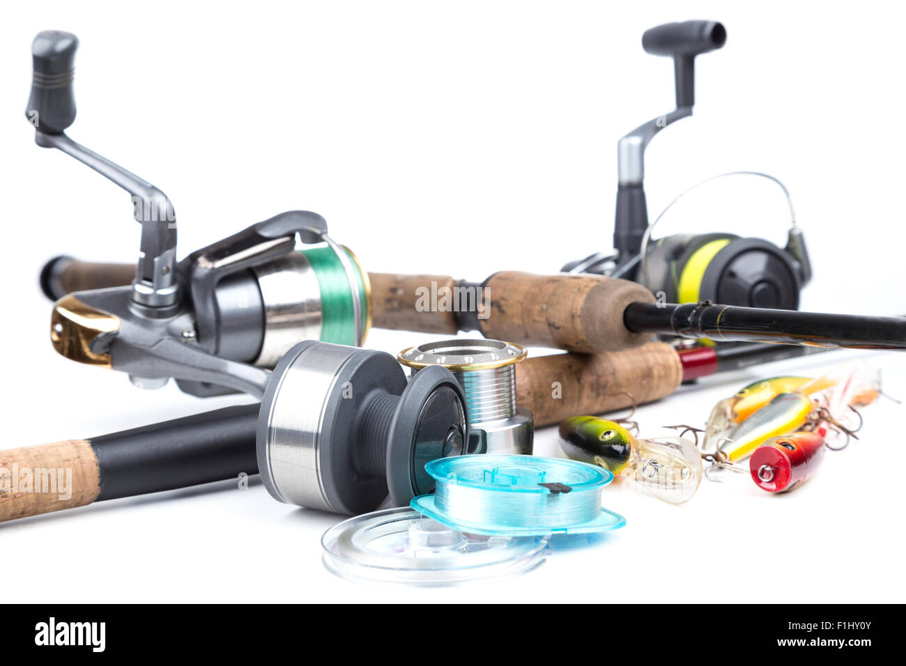 different fishing tackles - rod, reel, line and lures on white ...