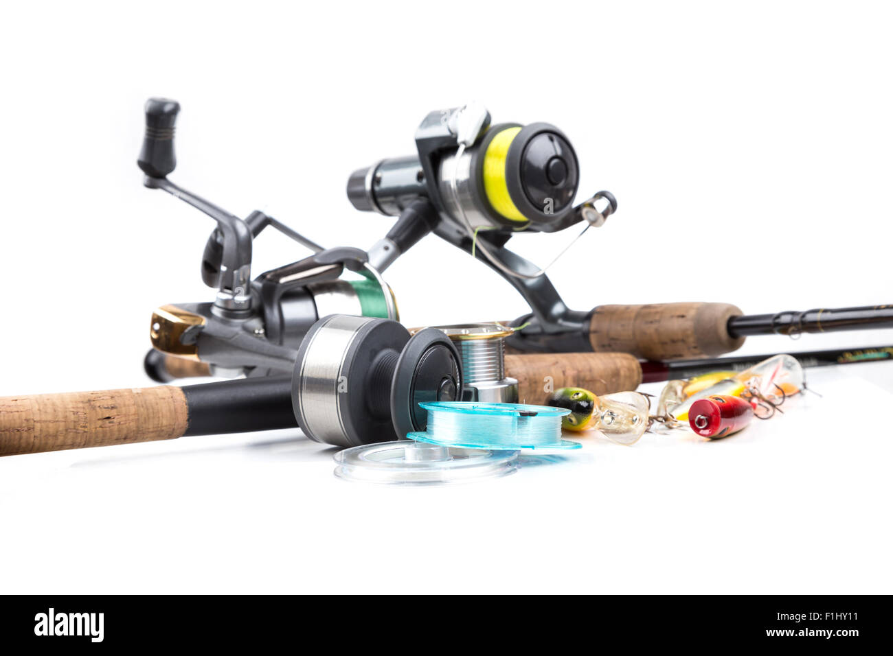 different fishing tackles - rod, reel, line and lures on white ...
